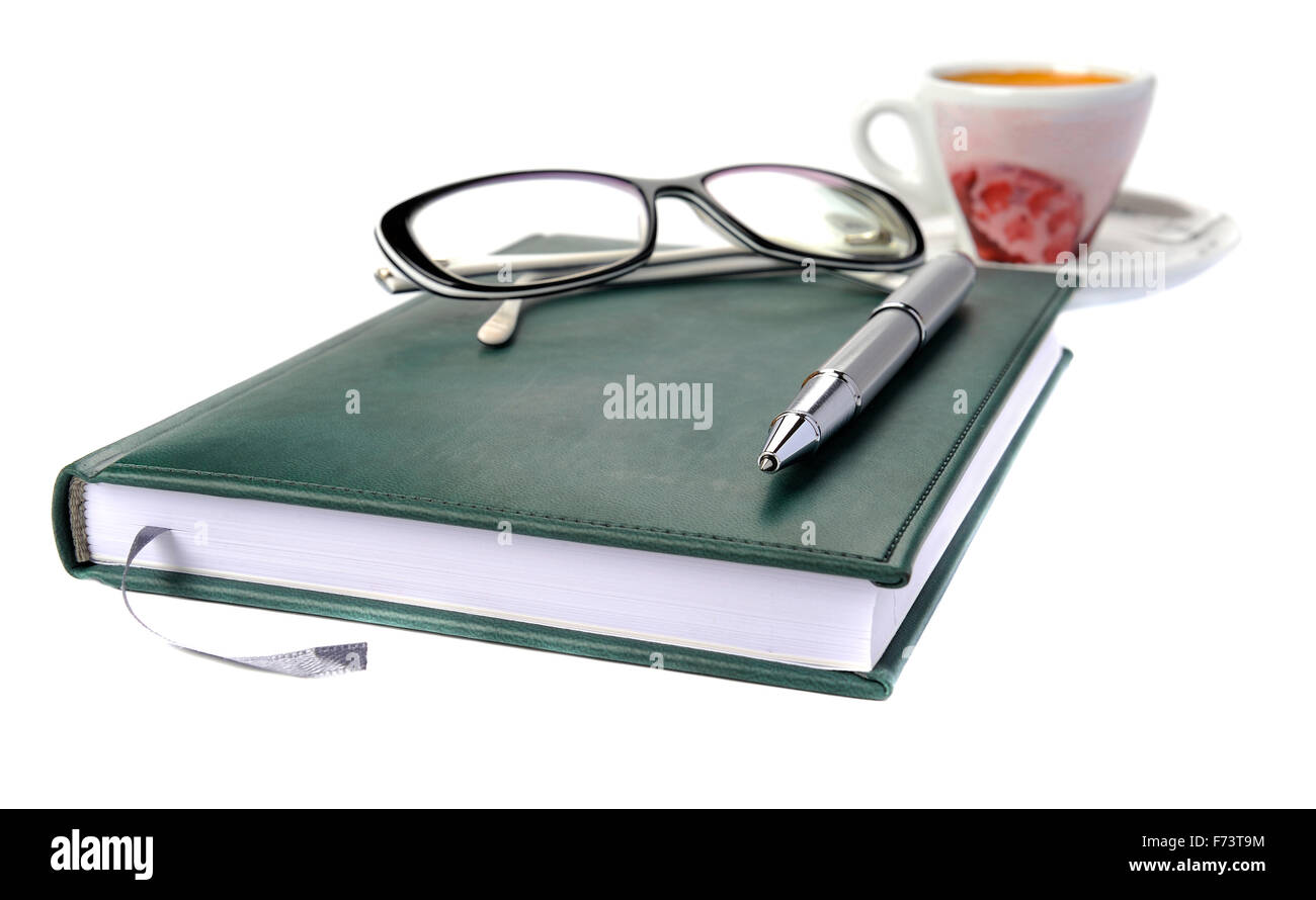 Diary with pen and cup of coffee and glasses, on a white background ...