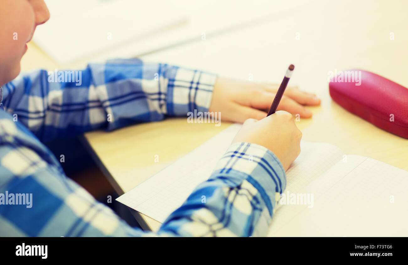 close up of schoolboy writing test at school Stock Photo - Alamy
