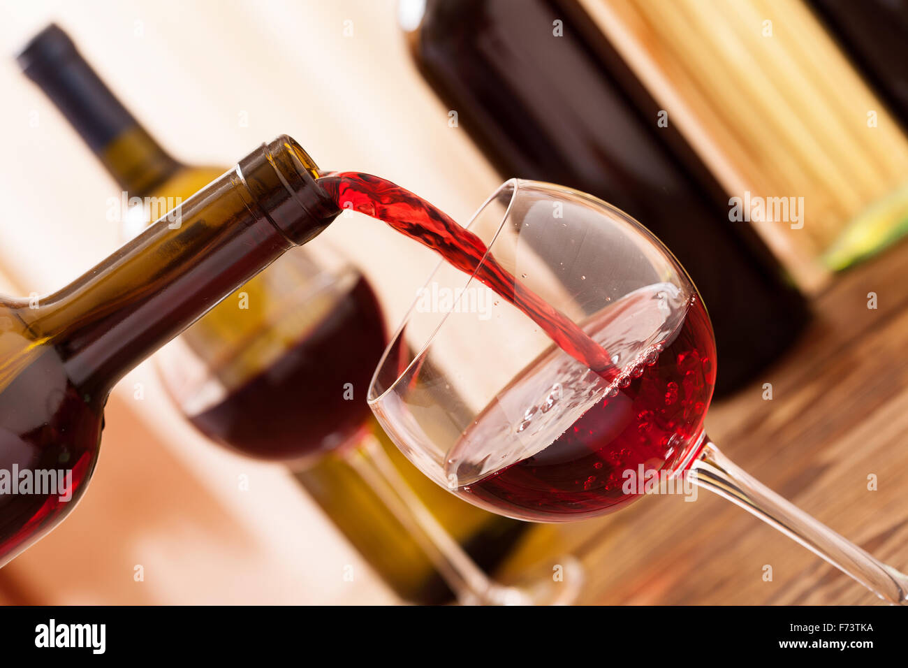 Red wine pouring into glass, close-up Stock Photo - Alamy