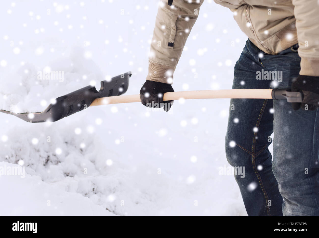 closeup of man digging snow with shovel Stock Photo - Alamy