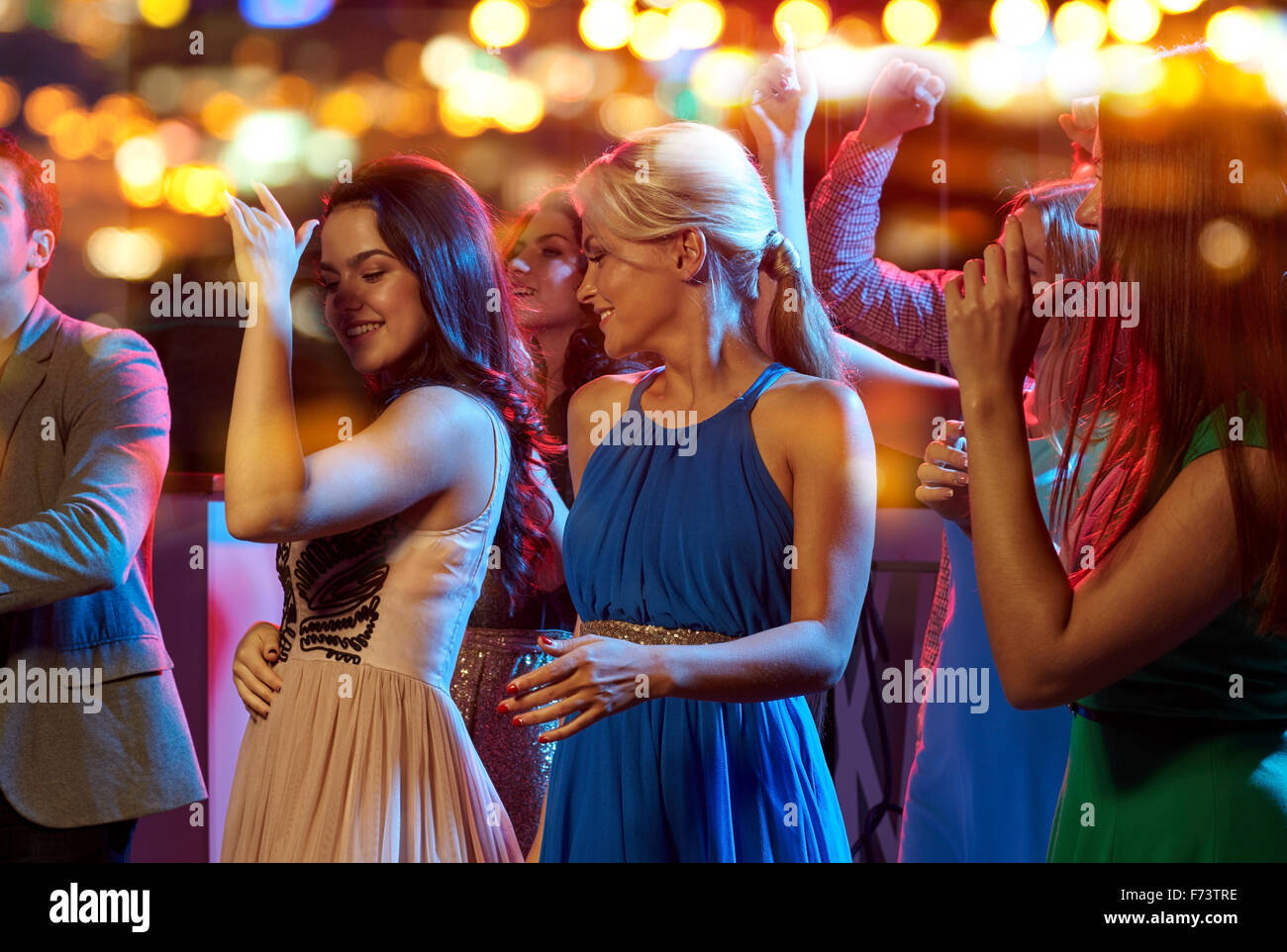 group of happy friends dancing in night club Stock Photo - Alamy