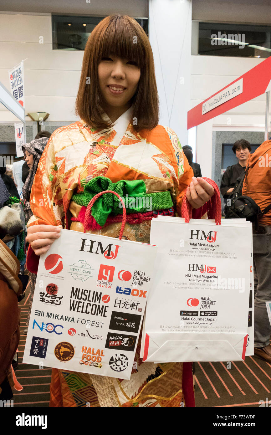 An exhibitor poses for a photograph during the Japan Halal Expo 2015 on November 25, 2015, Chiba ...