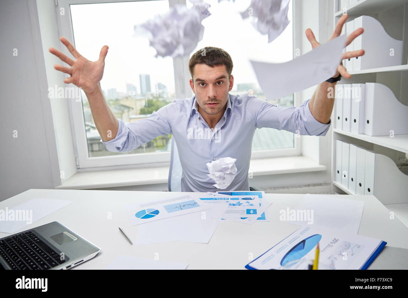 angry businessman throwing papers in office Stock Photo - Alamy