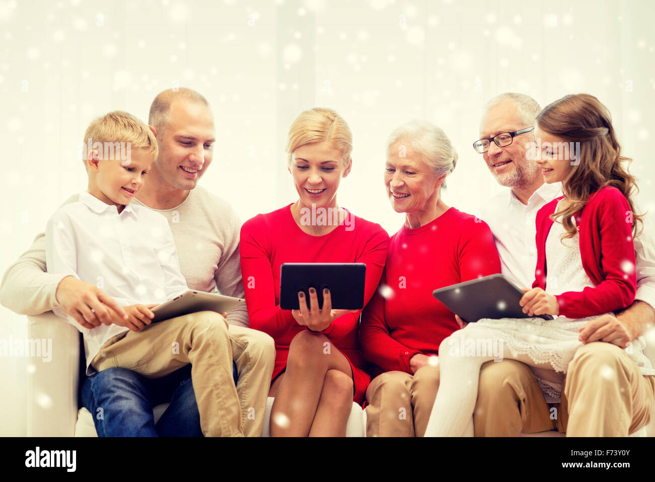 smiling family with tablet pc computers at home Stock Photo - Alamy