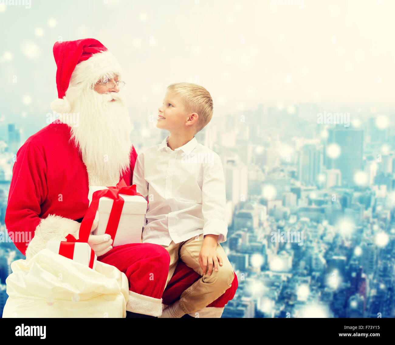 smiling little boy with santa claus and gifts Stock Photo - Alamy