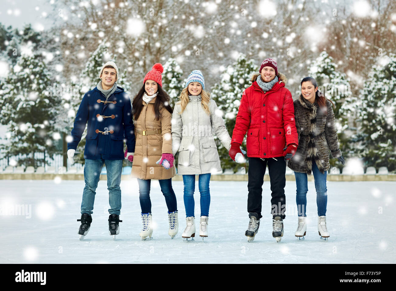 happy friends ice skating on rink outdoors Stock Photo - Alamy