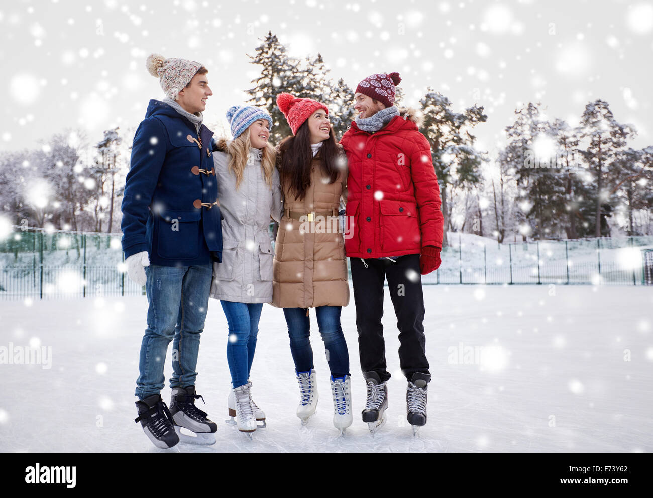 happy friends ice skating on rink outdoors Stock Photo - Alamy