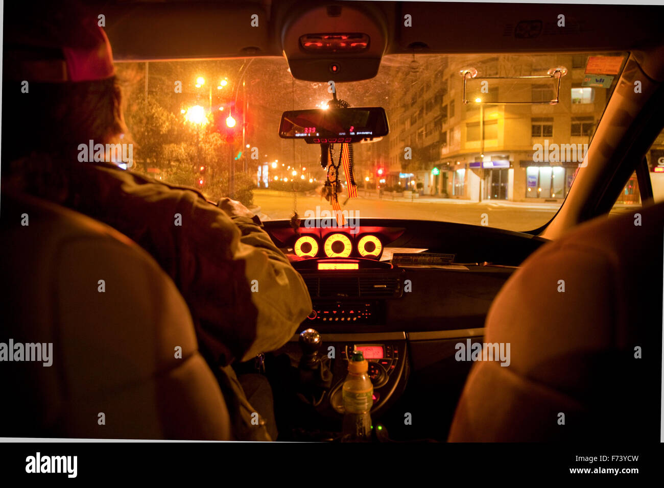 Taxi driver and street in night scene Stock Photo - Alamy