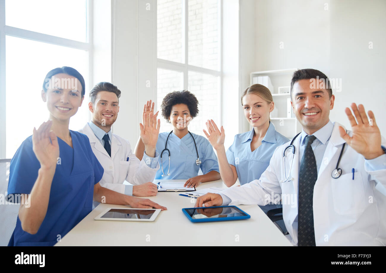 happy doctors meeting and waving hands at hospital Stock Photo - Alamy