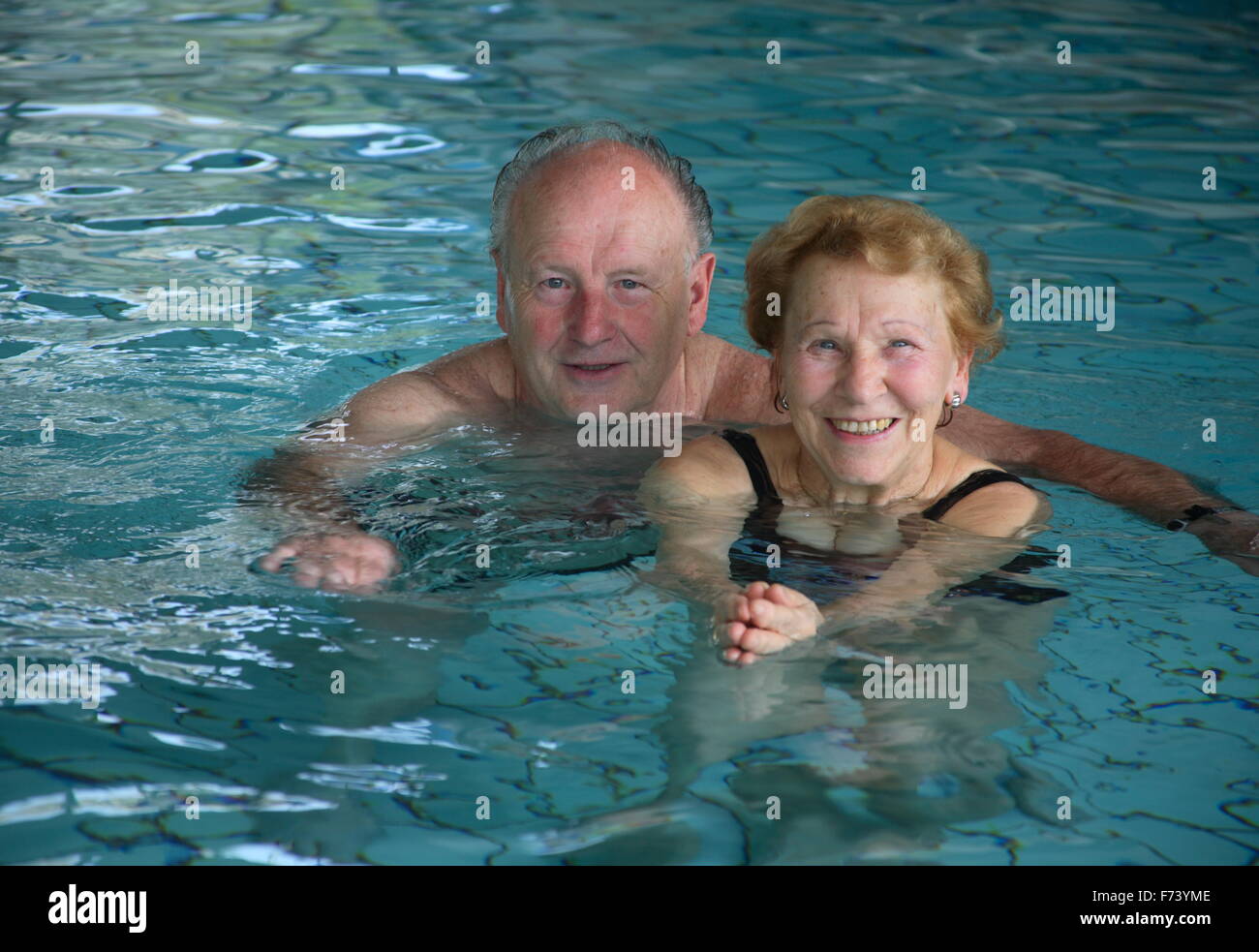 retired couple swimming in pool Stock Photo - Alamy