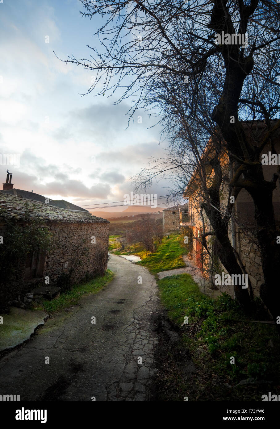 rural landscape with road,stone houses and tree Stock Photo - Alamy