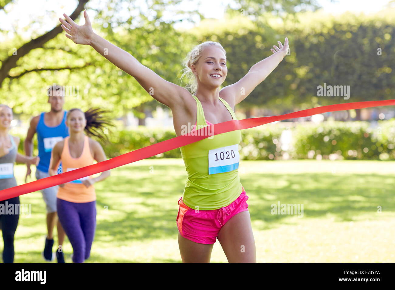 happy young female runner winning on race finish Stock Photo - Alamy