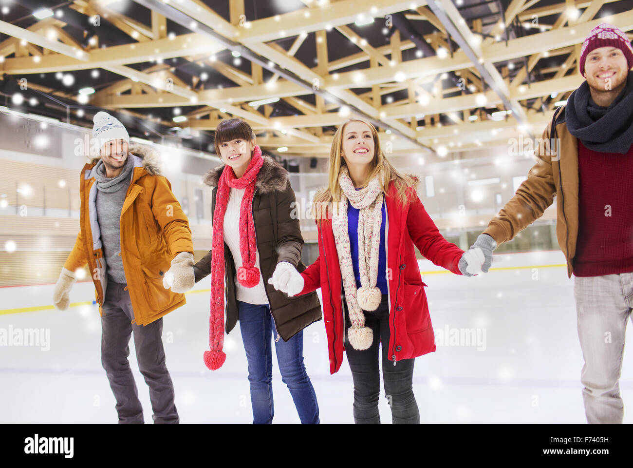 happy friends on skating rink Stock Photo - Alamy
