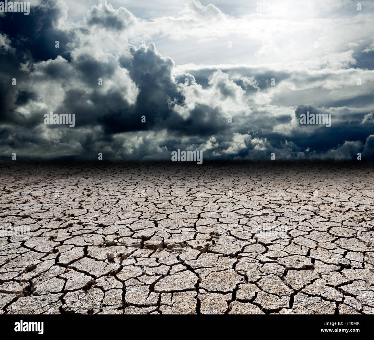 Landscape with storm clouds and dry soil Stock Photo - Alamy