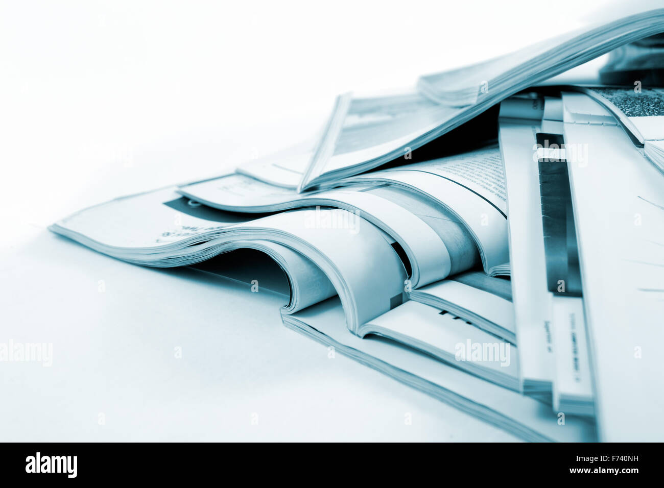 Detail of several magazines and books isolated in white Stock Photo - Alamy
