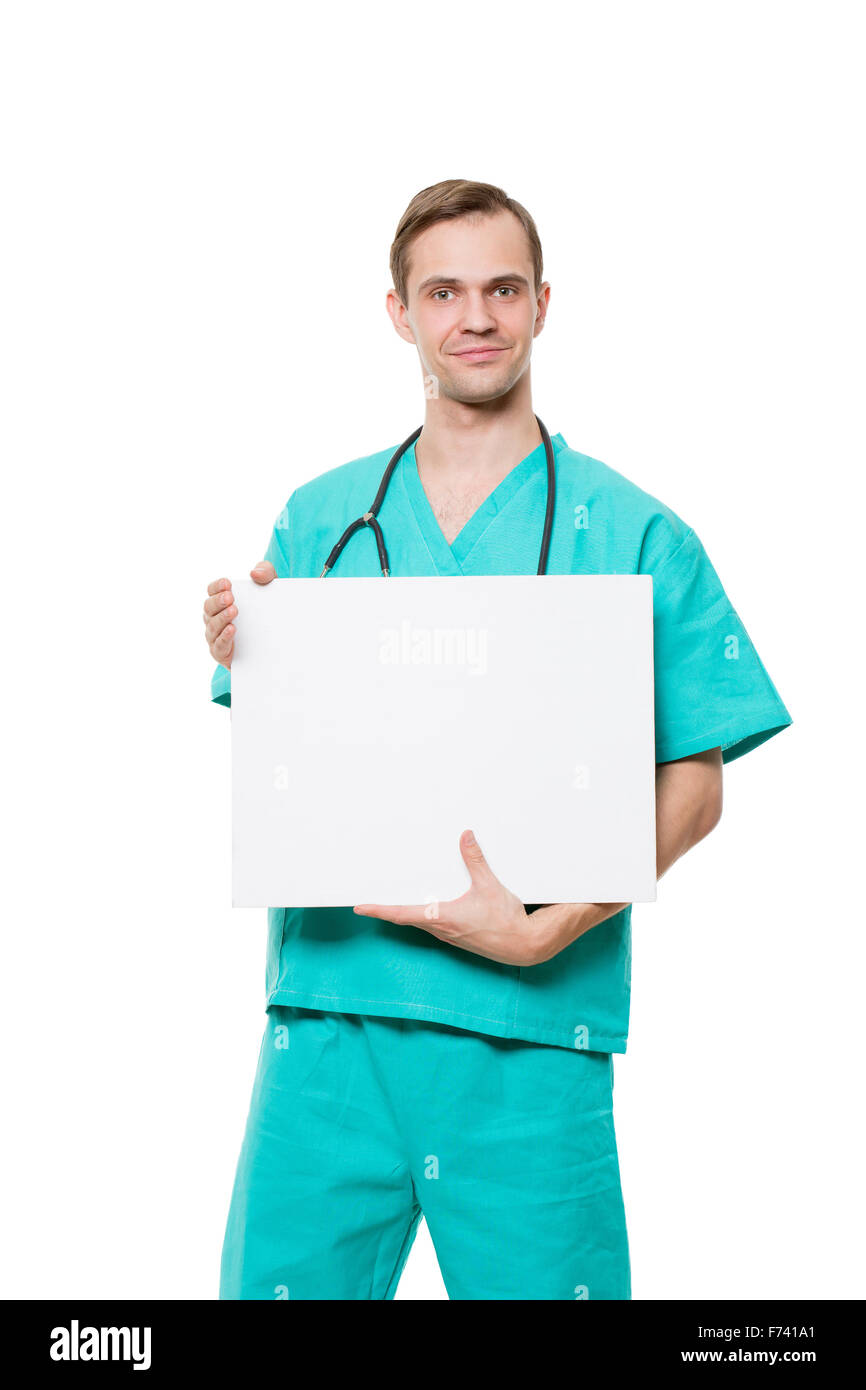 A smiling doctor holding a white blank card isolated on white ...