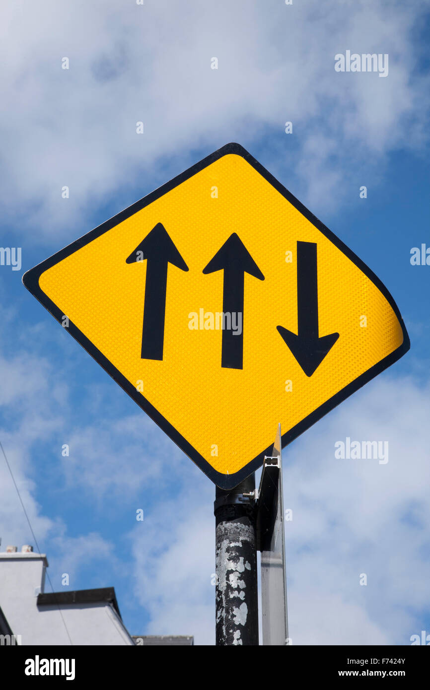 Yellow Three Arrow Sign against Blue Sky Background Stock Photo - Alamy