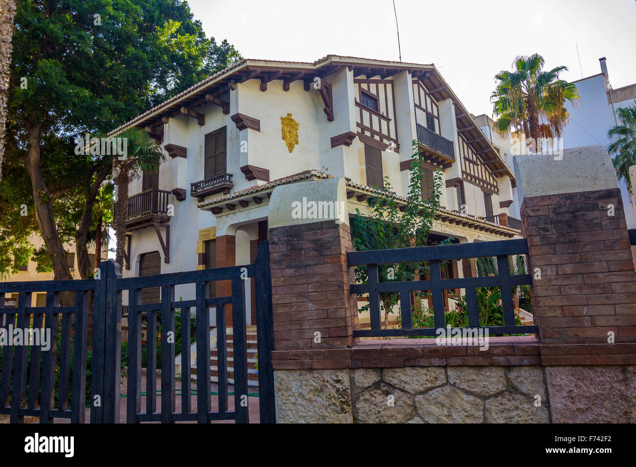 Pretty white house with wood Stock Photo - Alamy