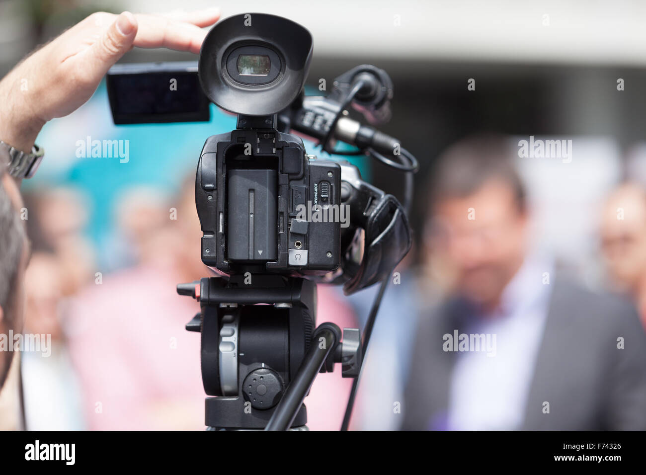 Filming an event with a video camera Stock Photo - Alamy