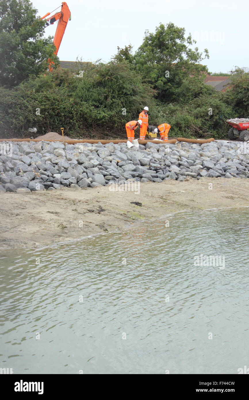 Building a seawater tidal defence along the waters edge in Portsmouth ...