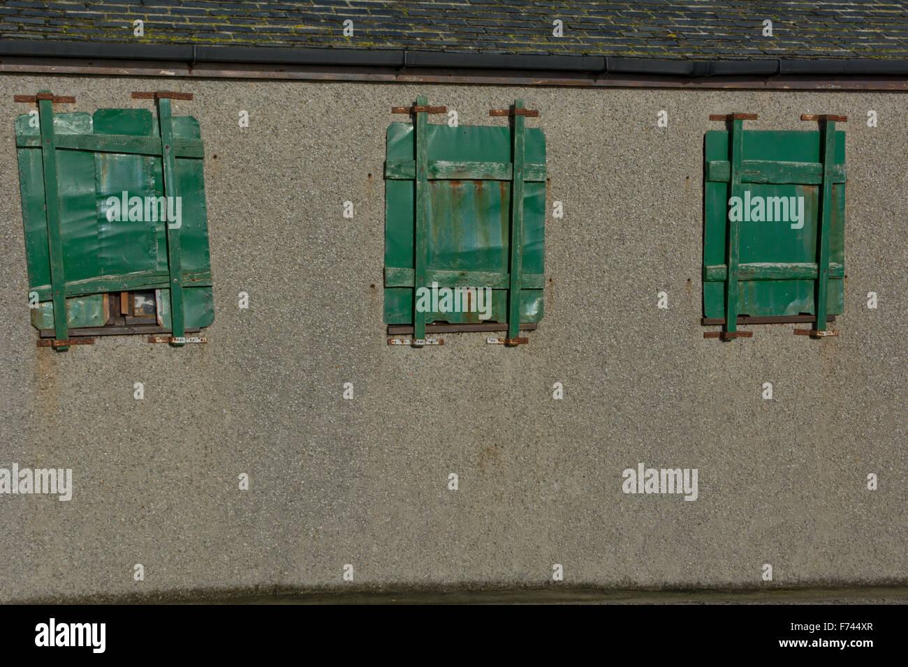 Boarded up windows on outside of public convenience Stock Photo - Alamy