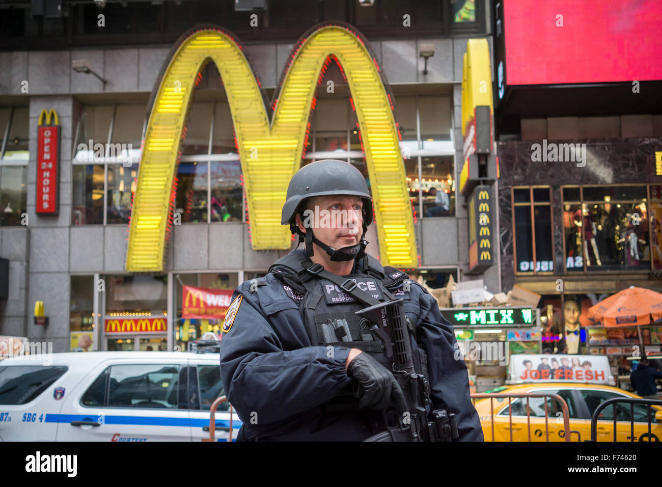 Officers from the NYPD Hercules team stand guard in Times Square on ...