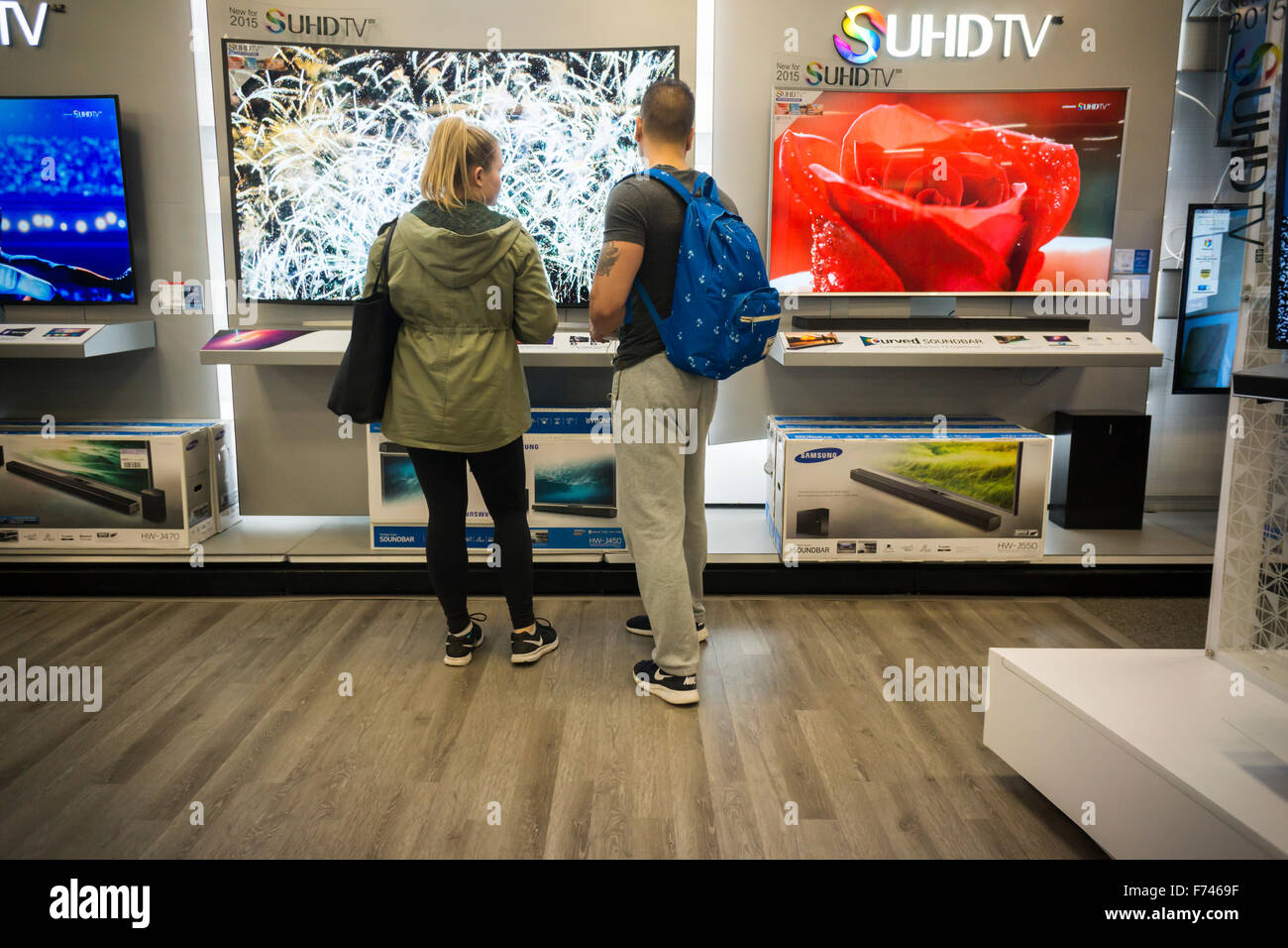 Customers browse Samsung 4K Ultra High Definition televisions in a Best ...