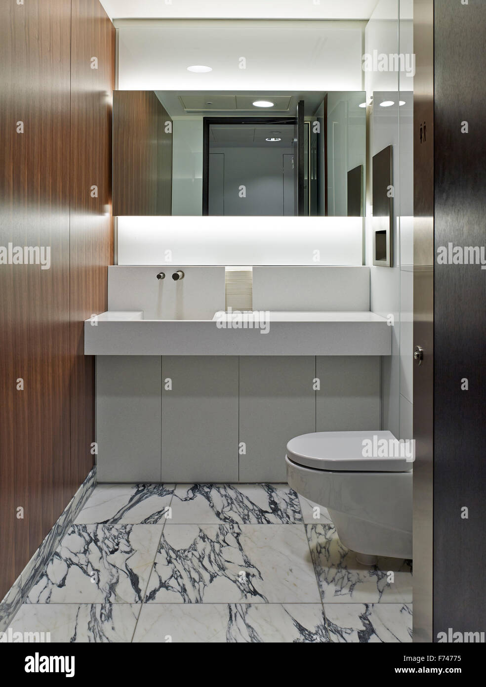 Marble floored washroom with wood panelled wall in Squire Sanders ...