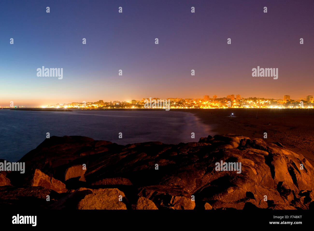 The sunset falling onto the beach Praia do Cabedelo do Douro, at the ...