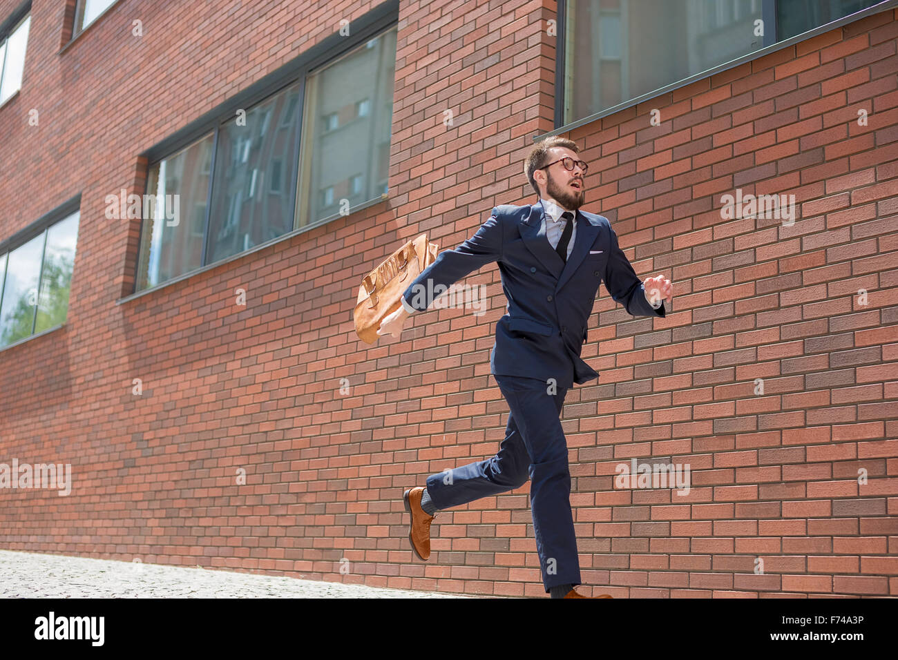 young businessman running in a city street Stock Photo - Alamy