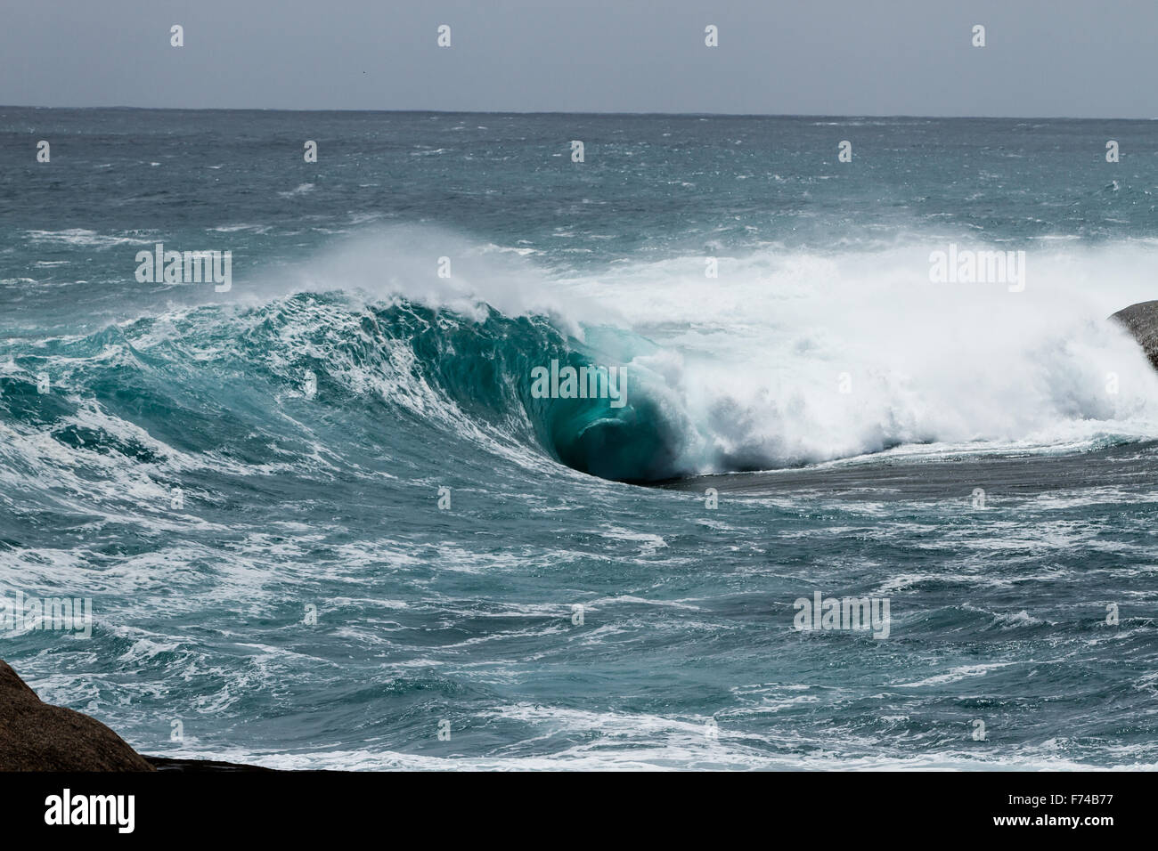 A heavy reef break exploding over dry reef Stock Photo - Alamy