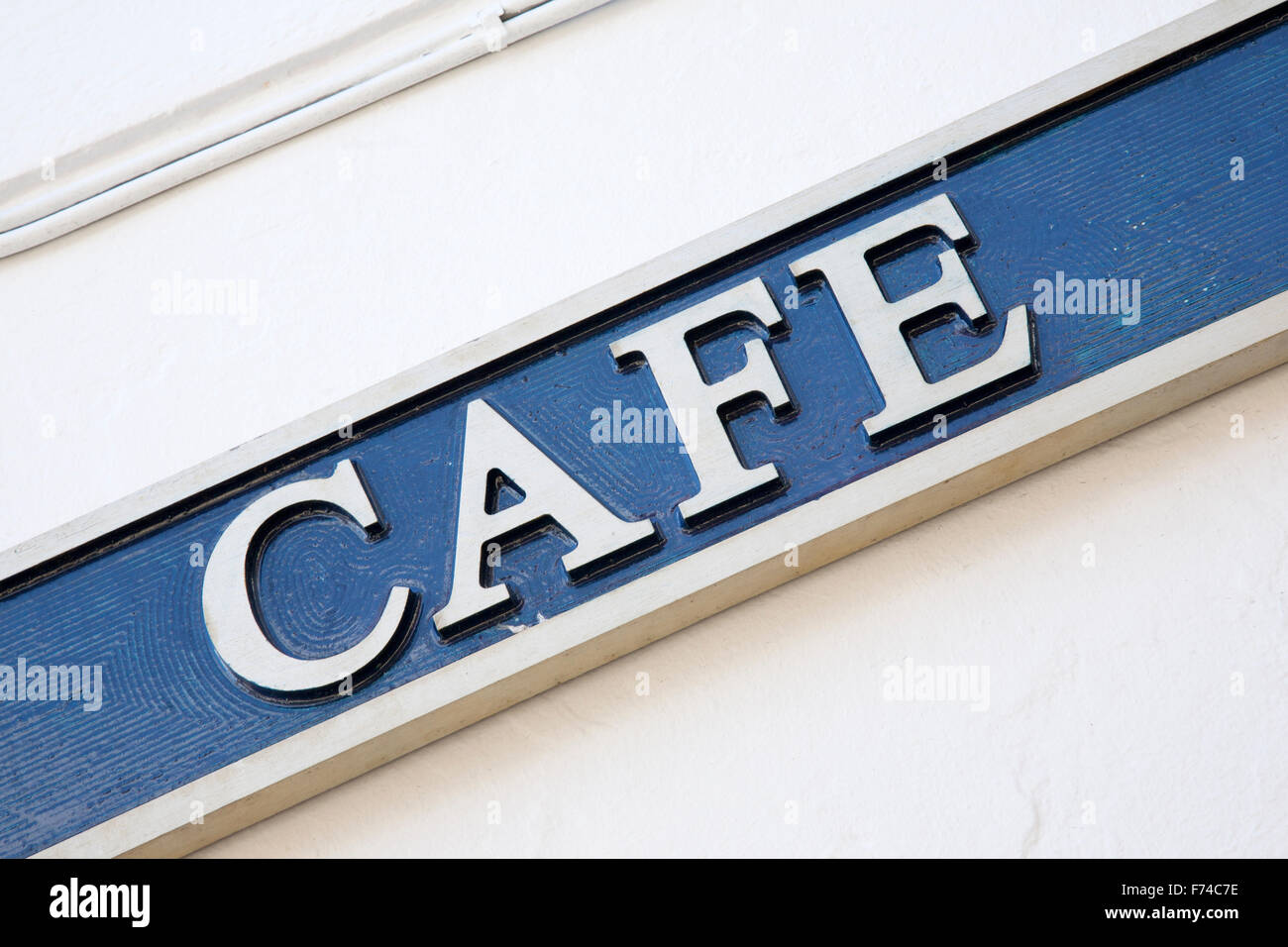 Blue and White Cafe Sign on Diagonla Tilt Stock Photo - Alamy