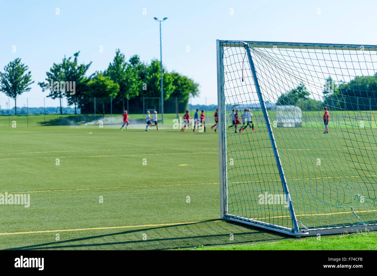 Children playing football school ground hi-res stock photography and ...