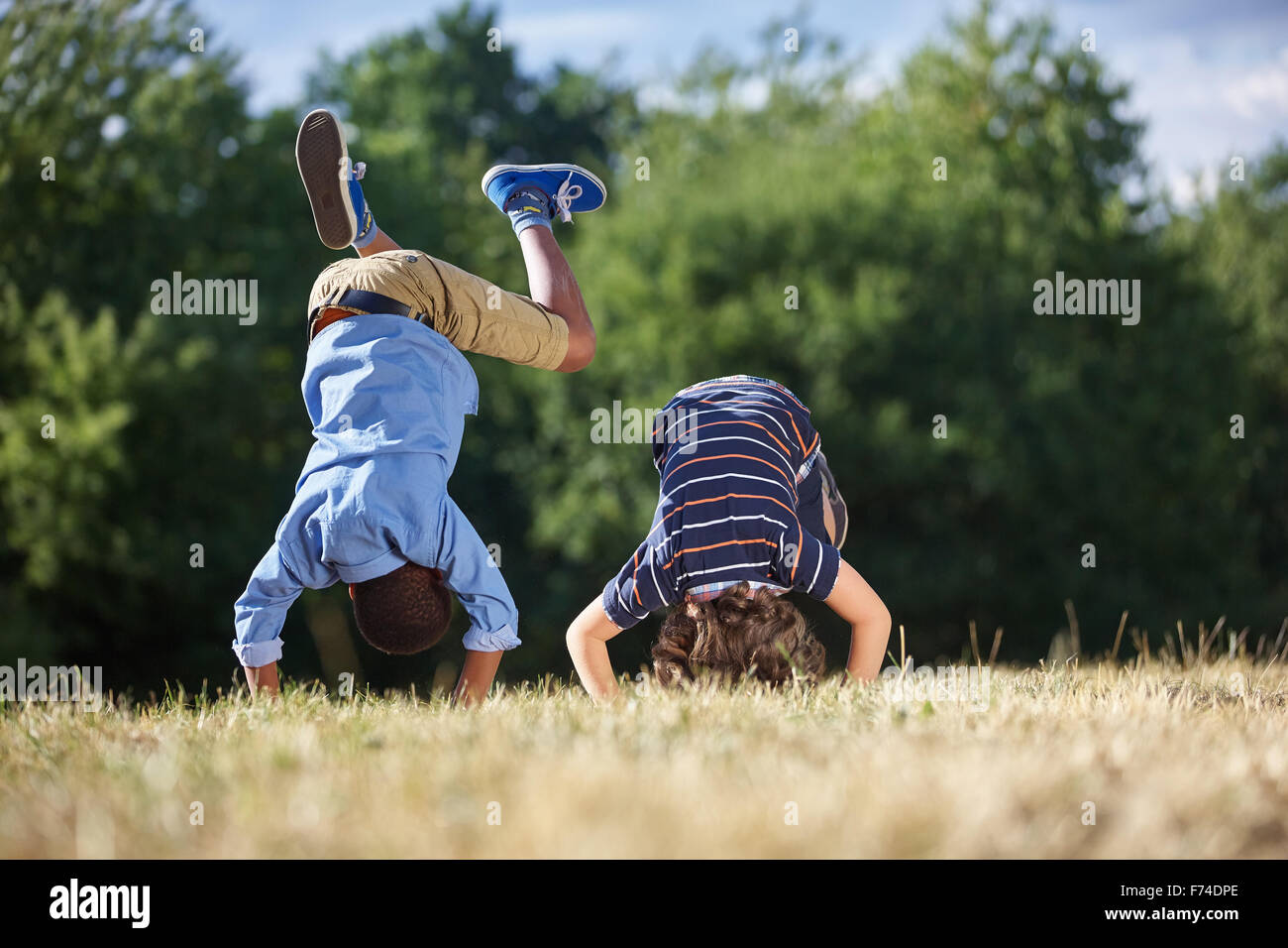 Two boys making a somersault and having fun at the park Stock Photo - Alamy