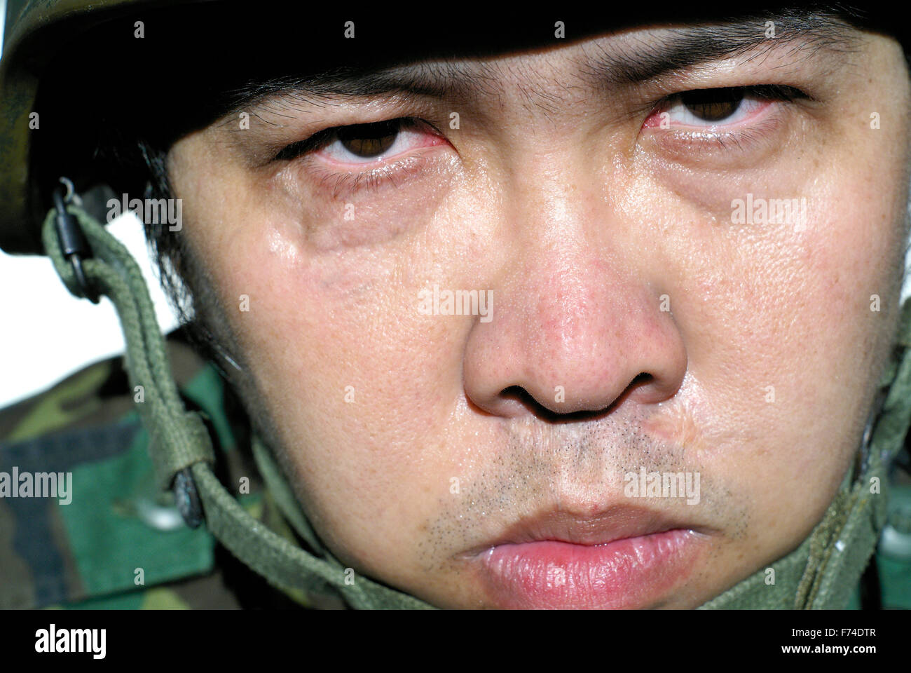 Grim asian soldier with helmet Stock Photo - Alamy