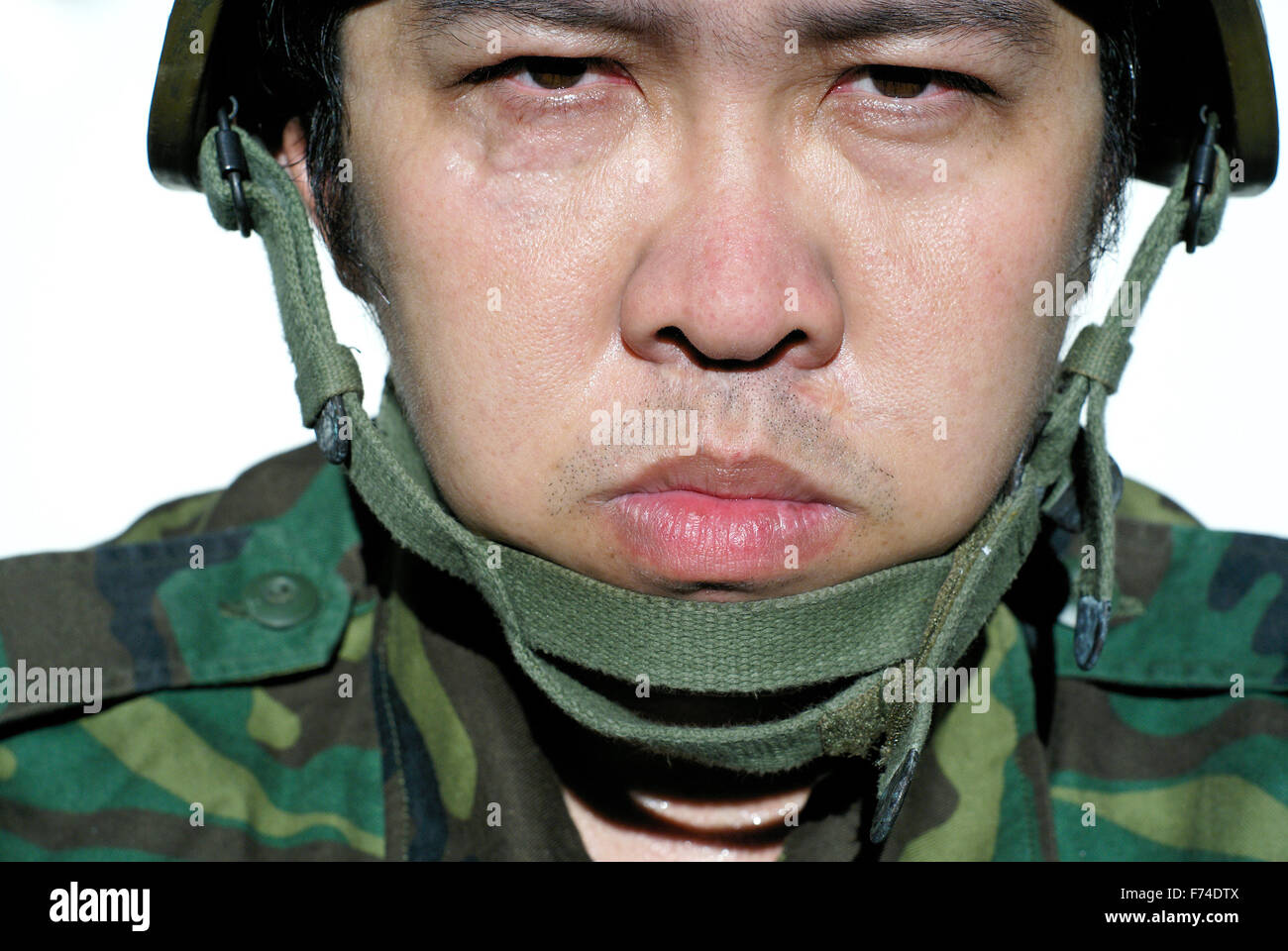 Staring asian soldier with helmet Stock Photo - Alamy