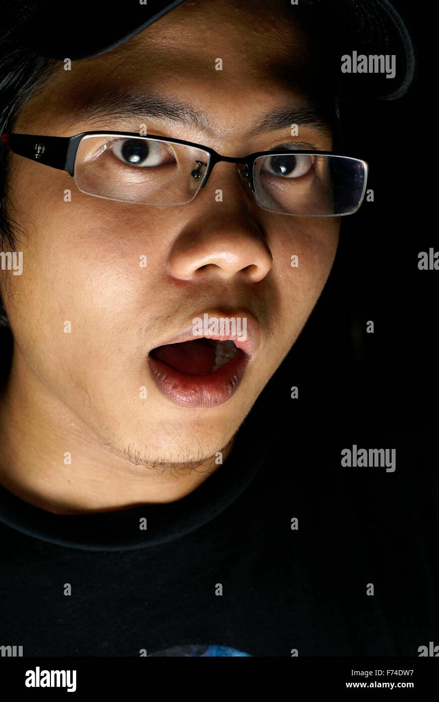 Asian man with frightened expression Stock Photo - Alamy