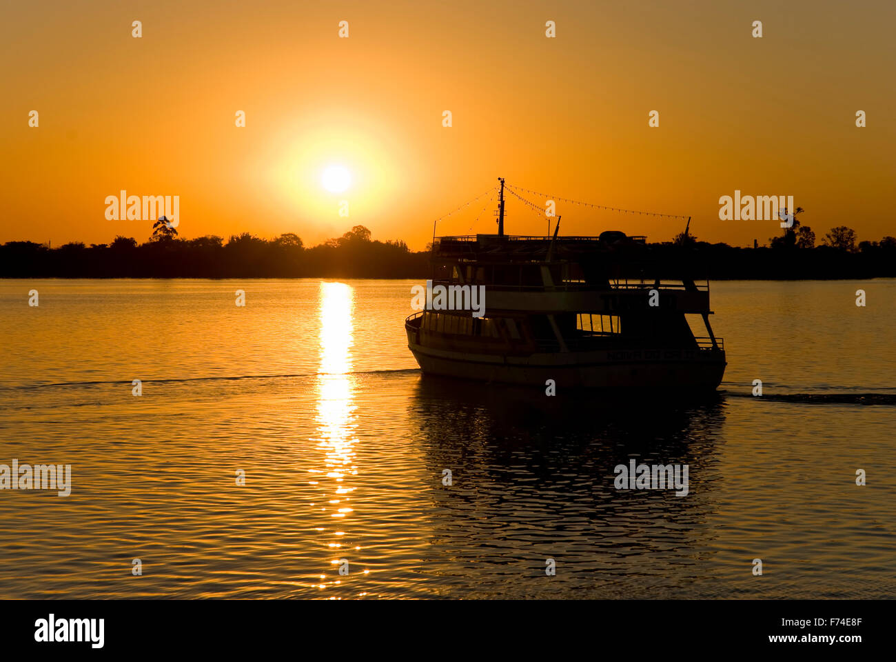 Boat in Sunset Stock Photo - Alamy