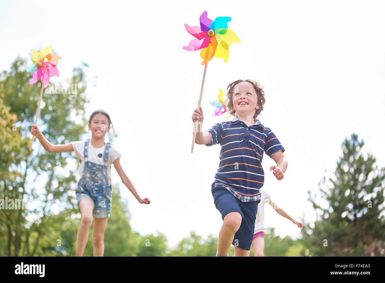 Kids with pinwheels playing at the park Stock Photo - Alamy