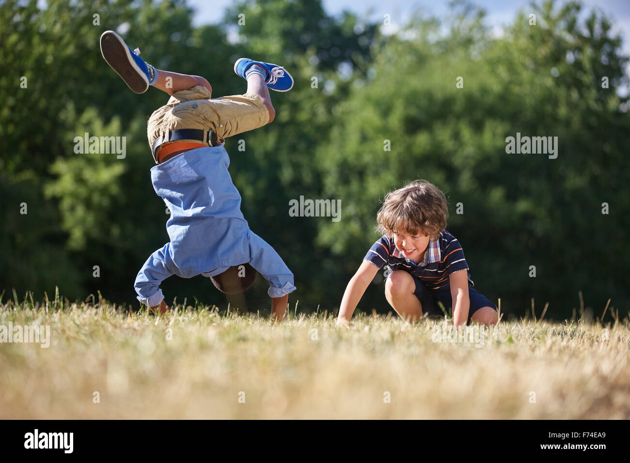 Two kids making a somersault and smiling in the nature Stock Photo - Alamy
