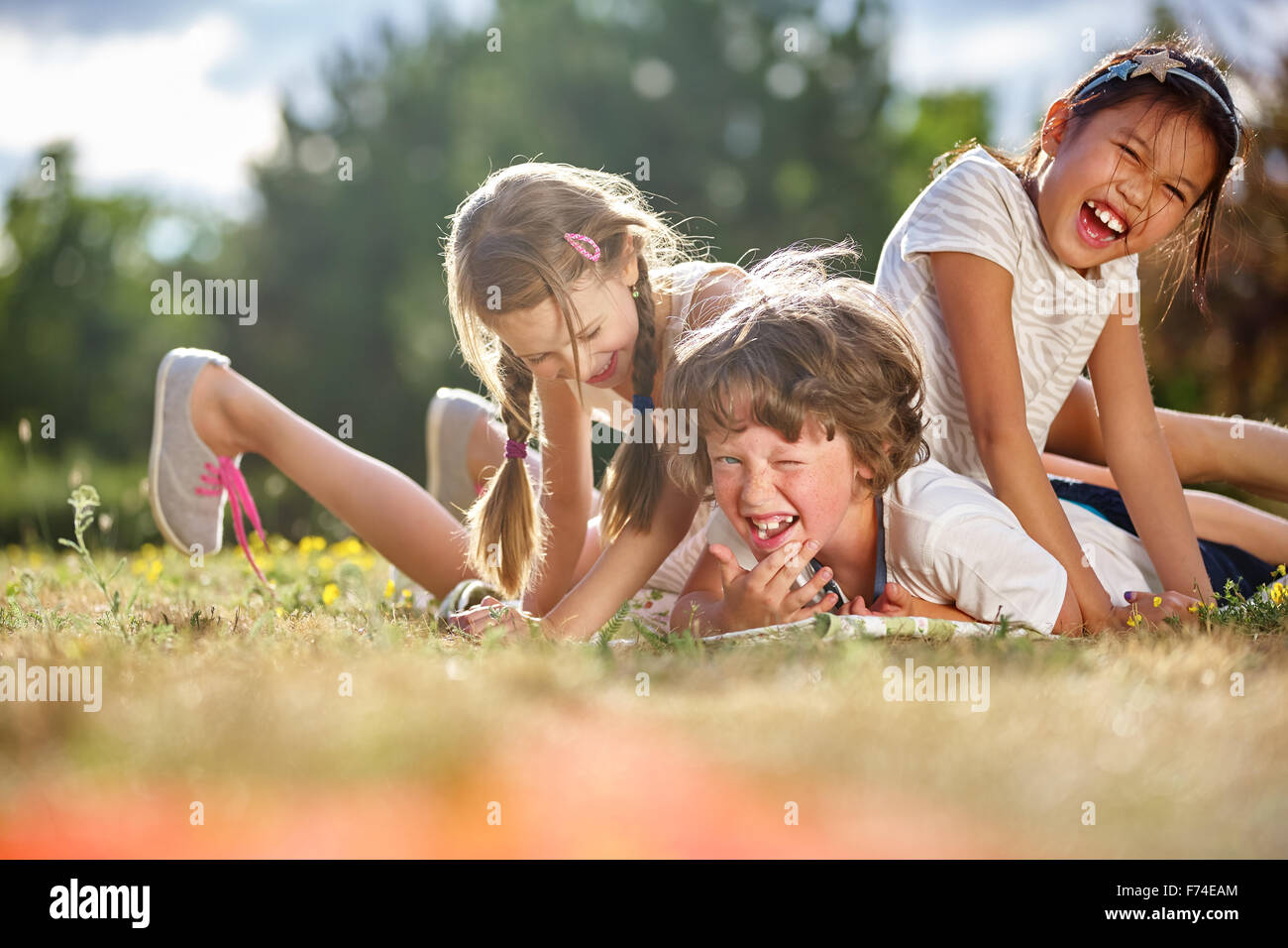 Happy children playing and having fun in summer Stock Photo - Alamy