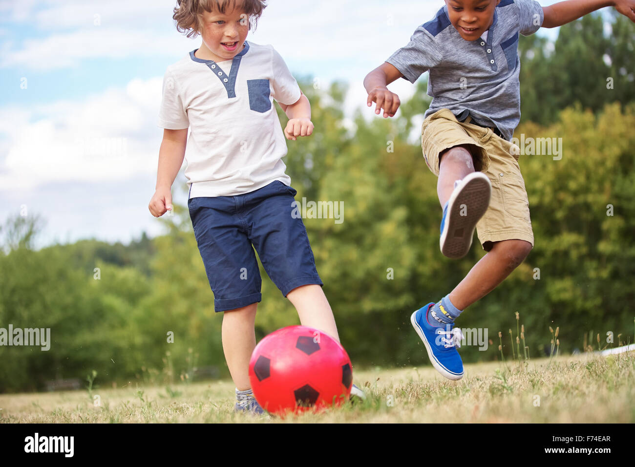 Children playing soccer and having fun in summer Stock Photo - Alamy