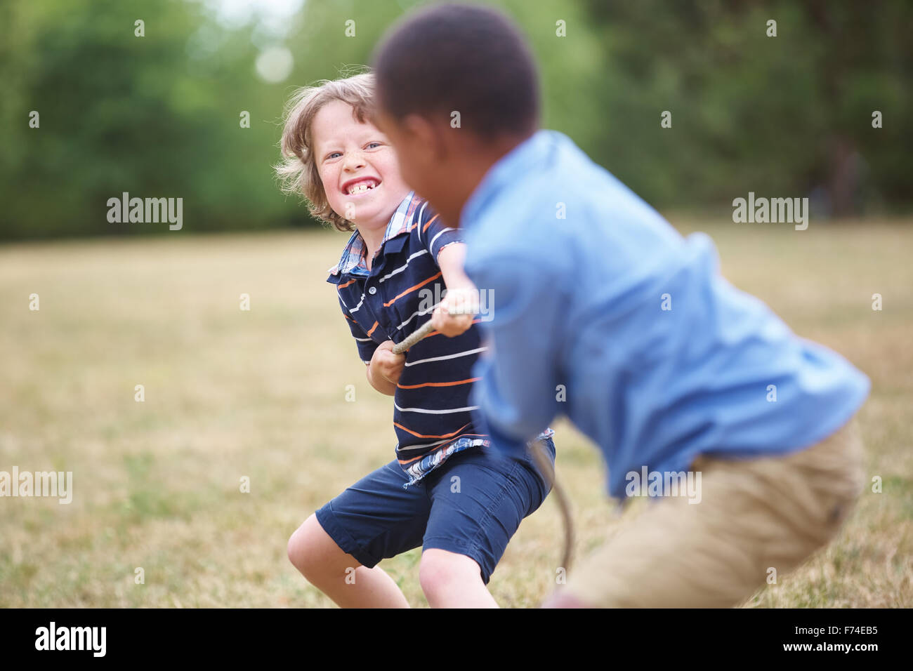 Two friends competing at a tug of war Stock Photo - Alamy