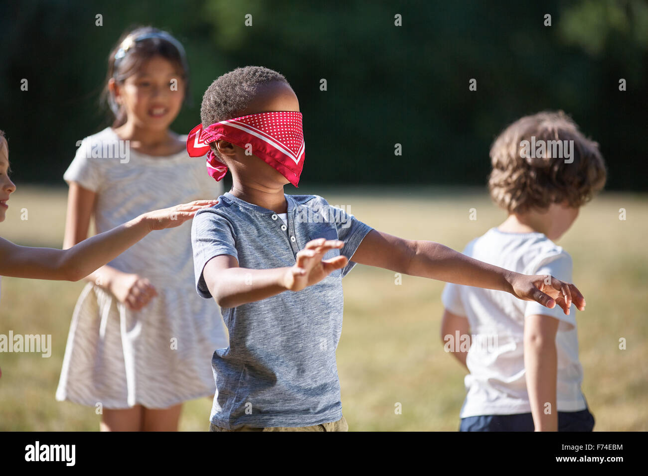 Children playing blind mans buff hi-res stock photography and images ...