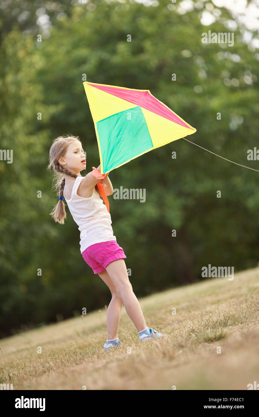 Girl playing with kite in the nature Stock Photo - Alamy