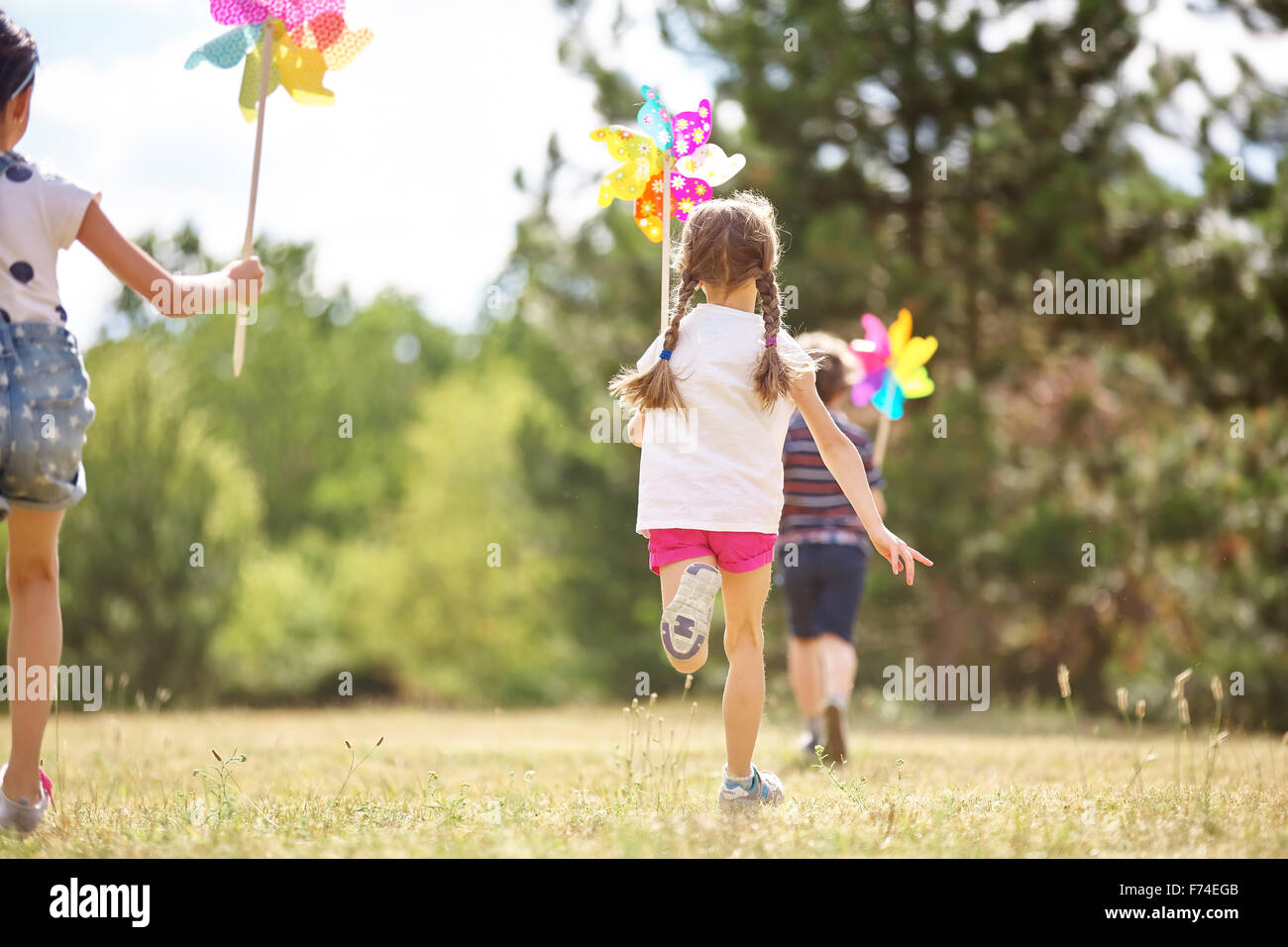 Kids playing with pinwheels and having fun Stock Photo - Alamy
