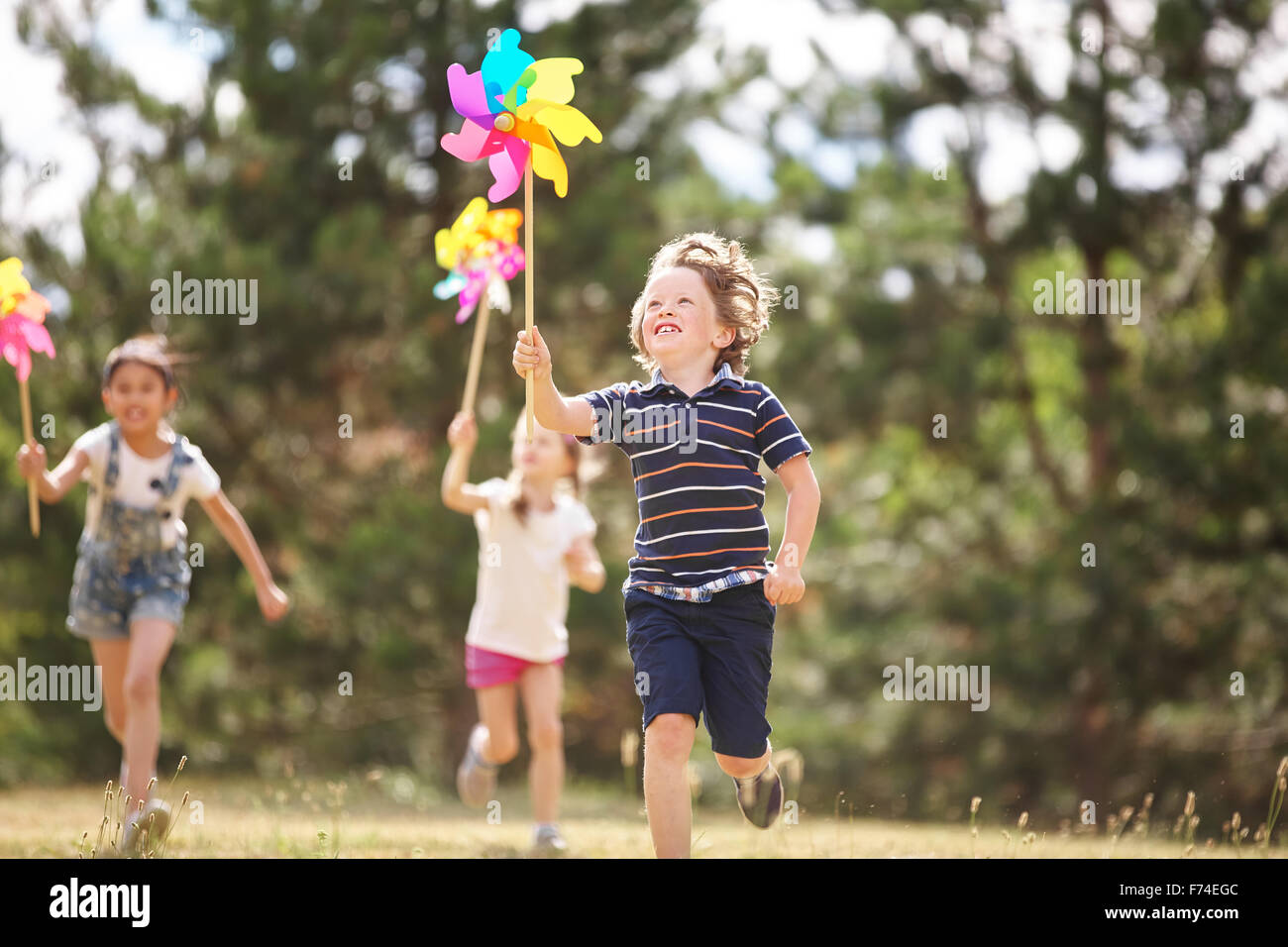 Group of happy children with pinwheels at the park Stock Photo - Alamy