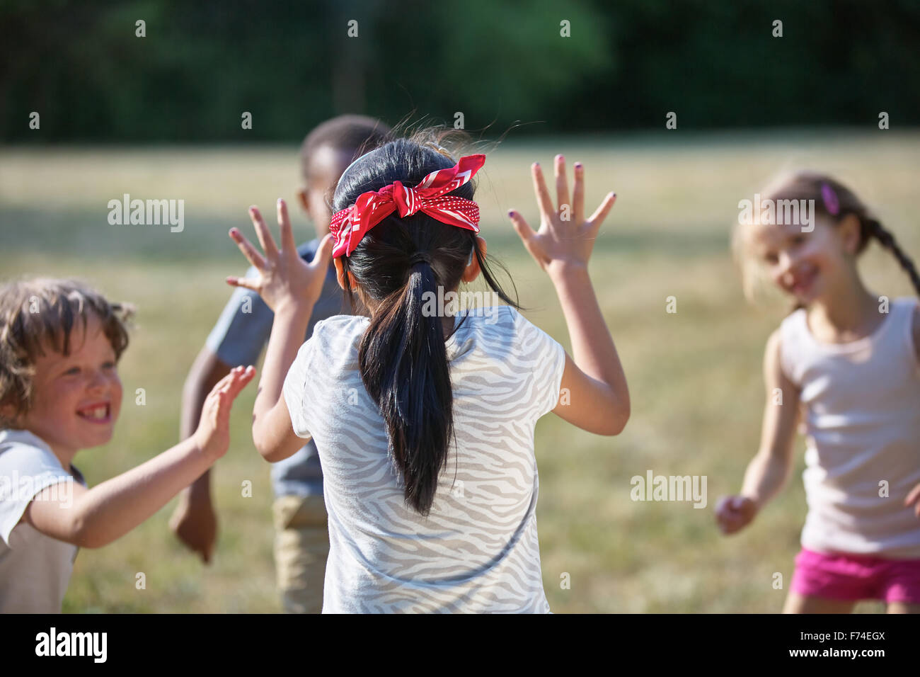 Happy kids playing blind man's buff at a birthday party Stock Photo - Alamy