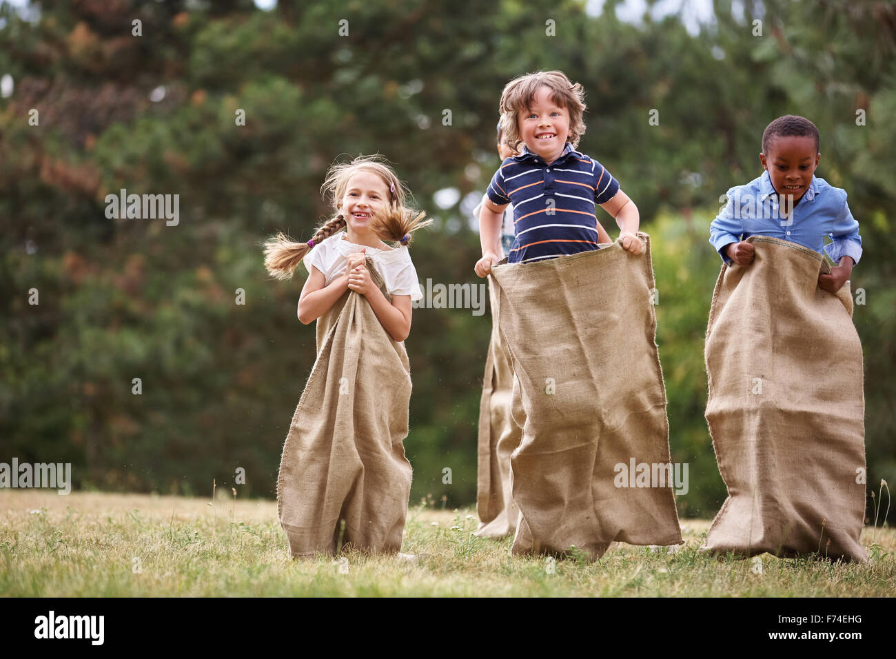 Children competing at sack race and having fun Stock Photo - Alamy