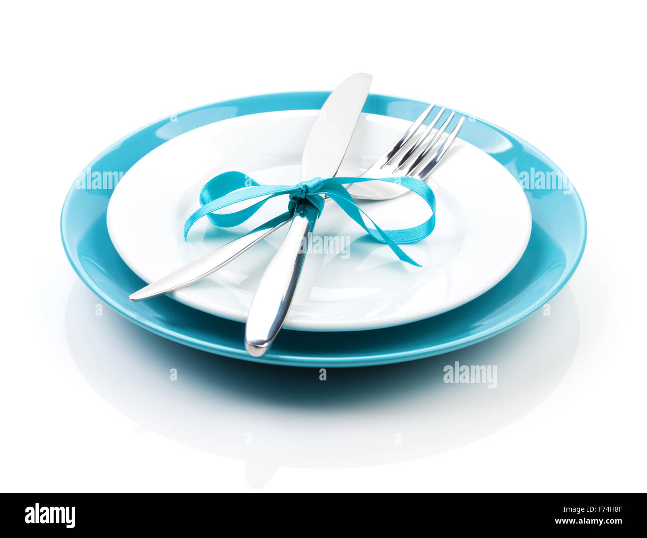 Fork with knife over blank plates. Isolated on white background Stock ...